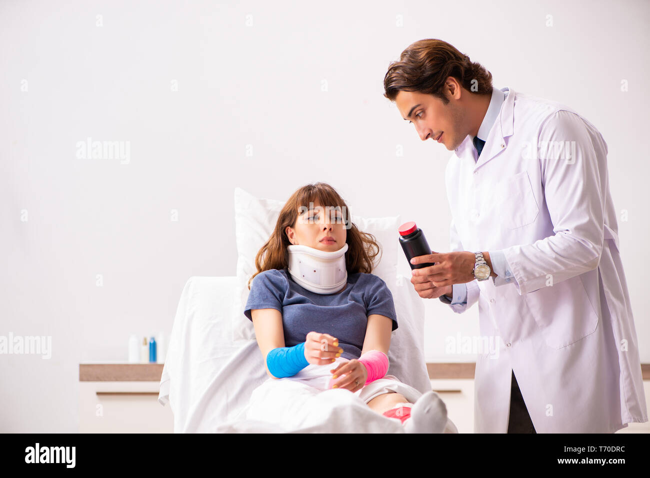 Young doctor examining injured patient Stock Photo - Alamy