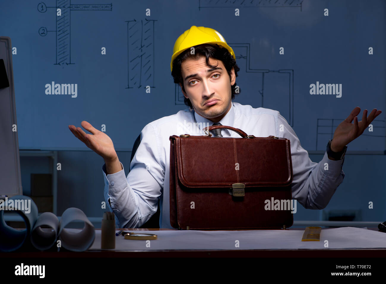 Young construction architect working on project at night Stock Photo ...