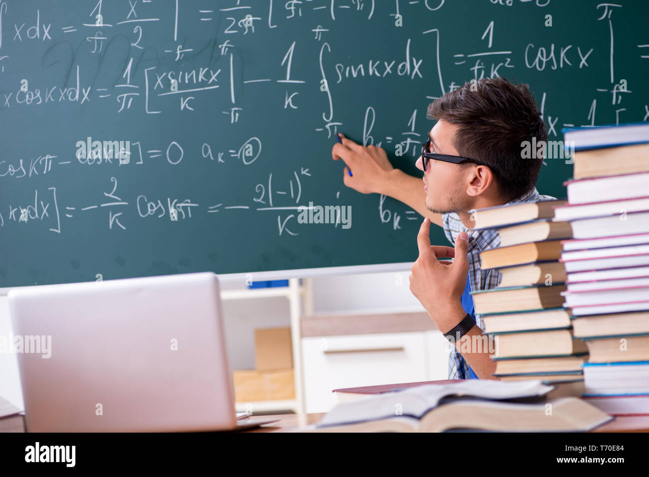 Young male student studying math at school Stock Photo - Alamy