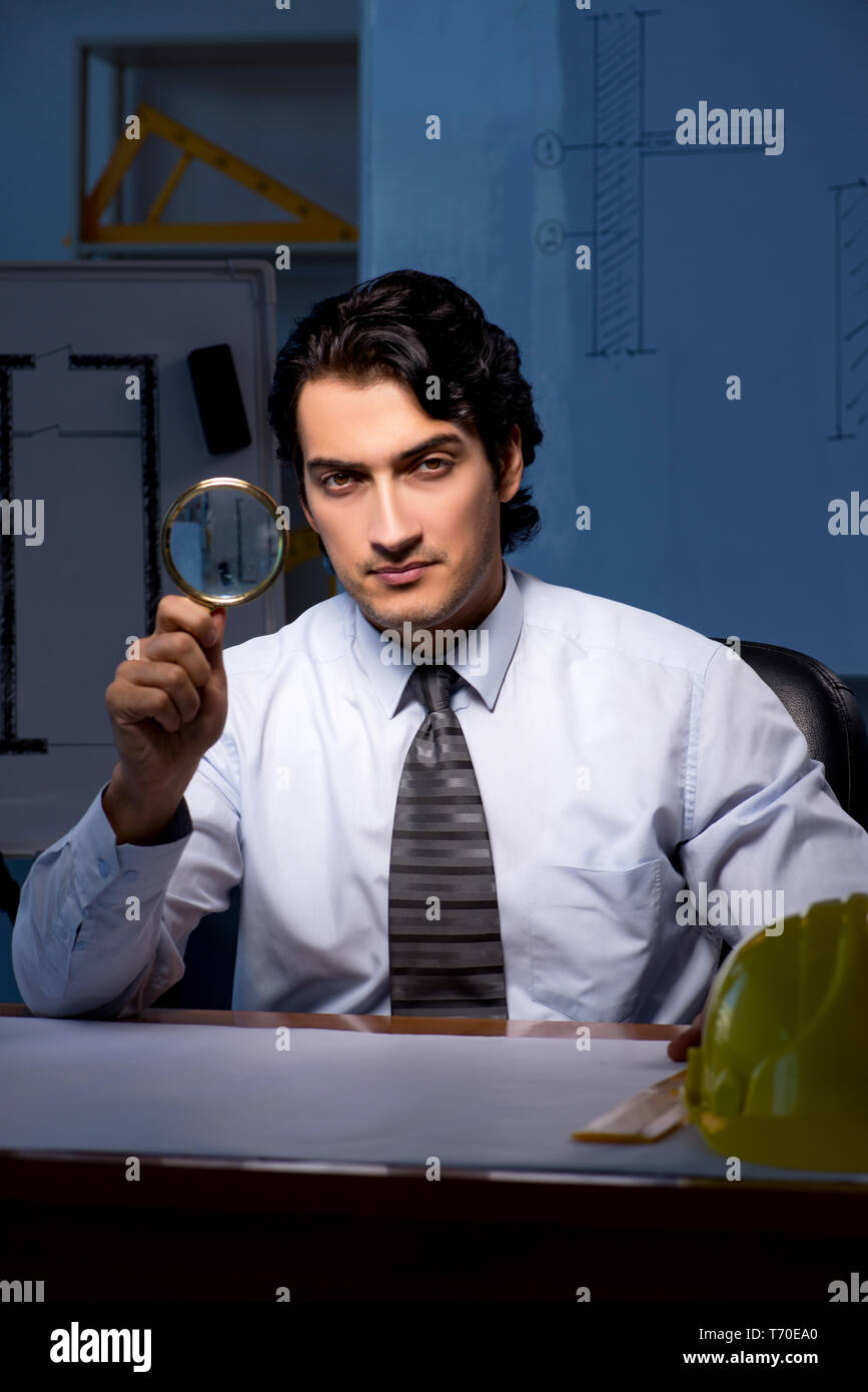 Young construction architect working on project at night Stock Photo ...
