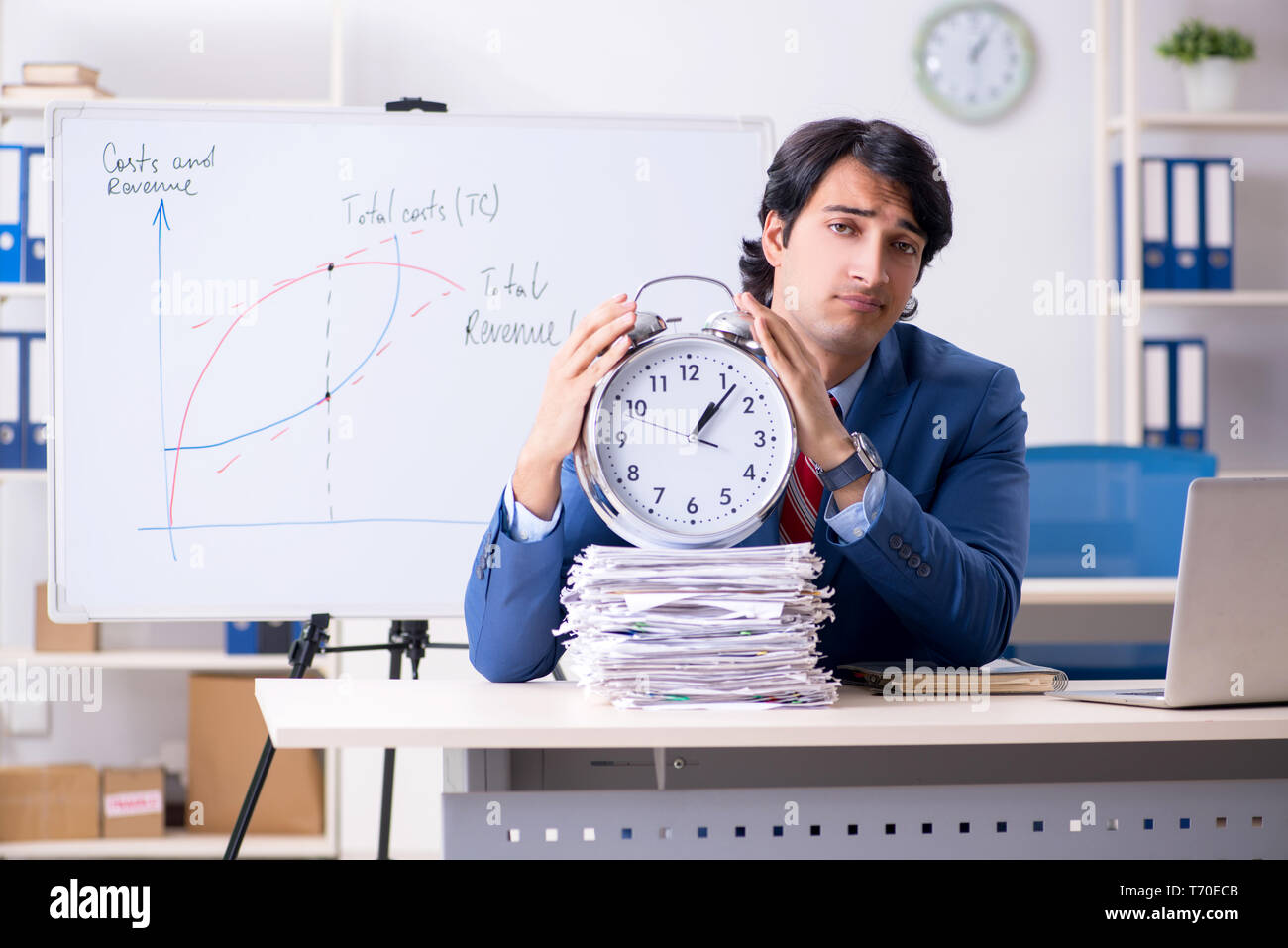 Busy businessman explaining business charts Stock Photo - Alamy
