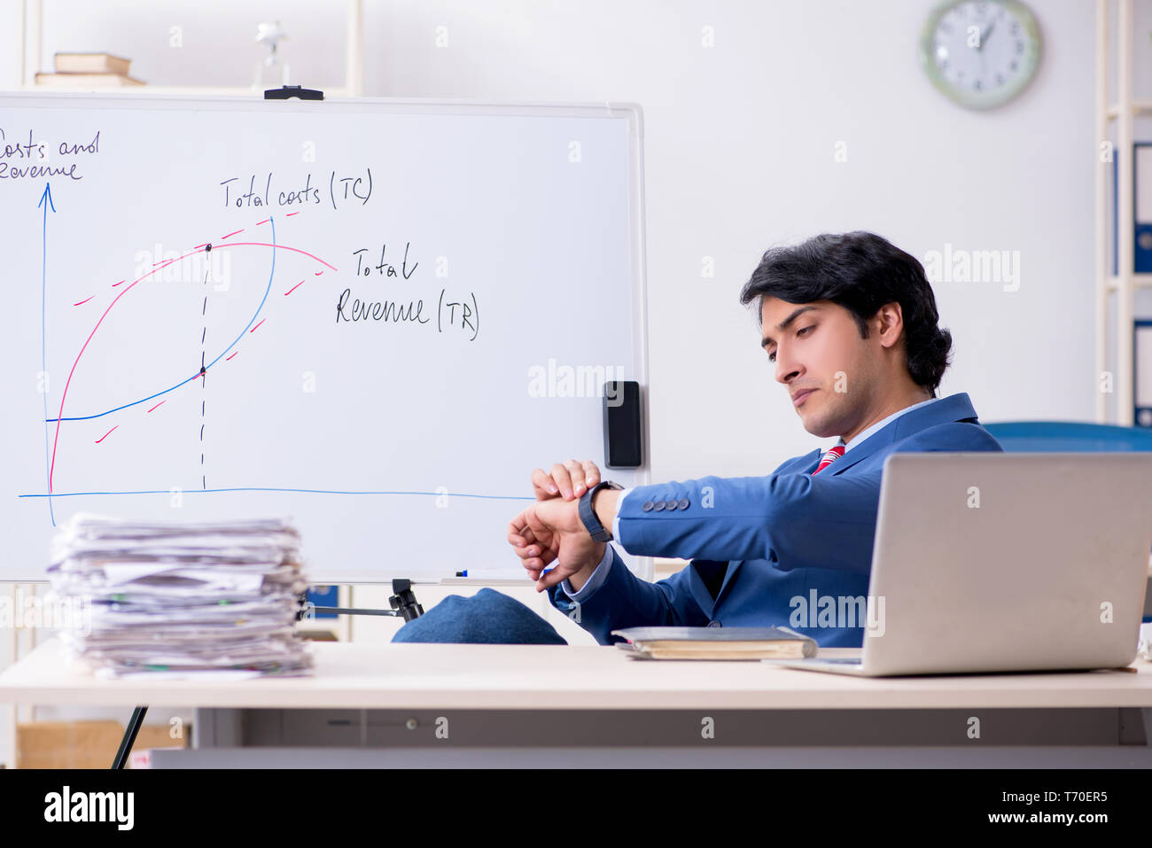 Busy businessman explaining business charts Stock Photo - Alamy