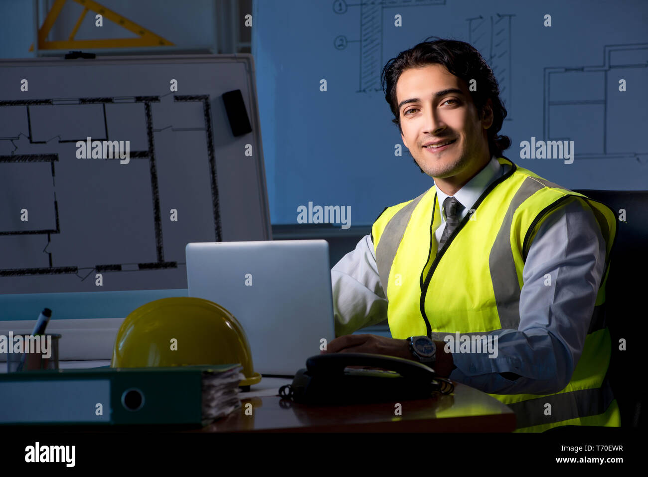 Young construction architect working on project at night Stock Photo ...