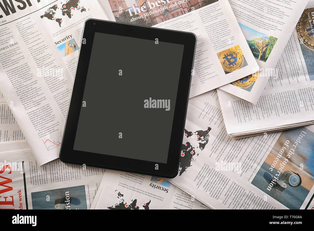 Tablet computer on newspapers Stock Photo - Alamy