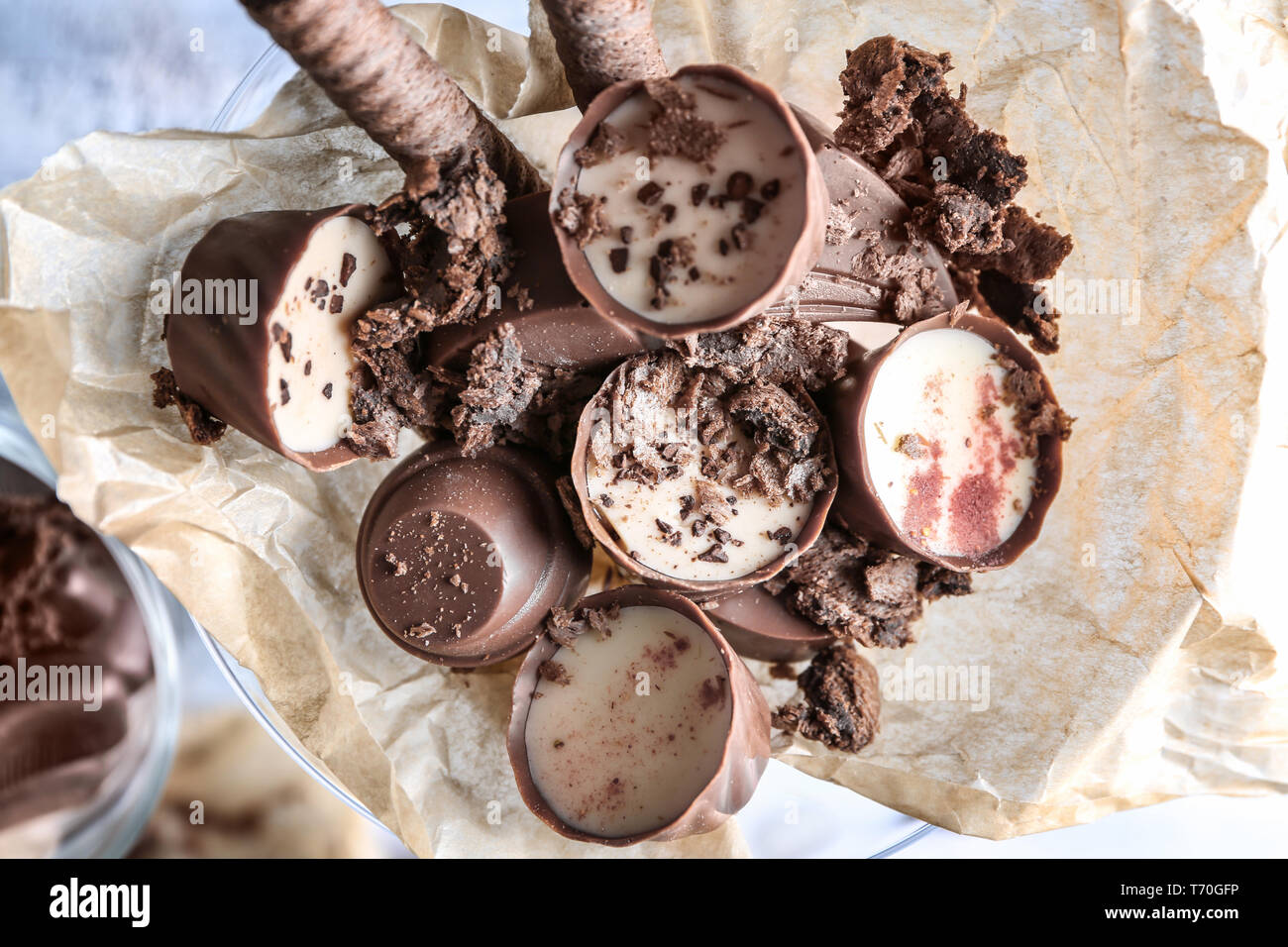 Delicious chocolate candies on parchment Stock Photo - Alamy