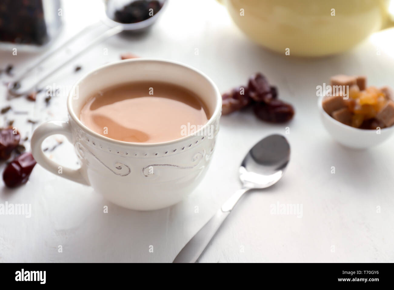 Cup of aromatic tea with milk on wooden table Stock Photo - Alamy