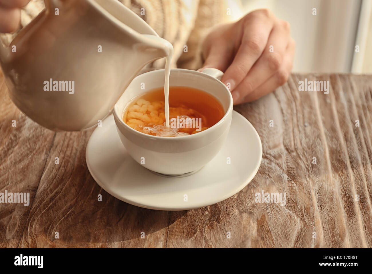 Woman pouring aromatic tea cup hi-res stock photography and images - Alamy