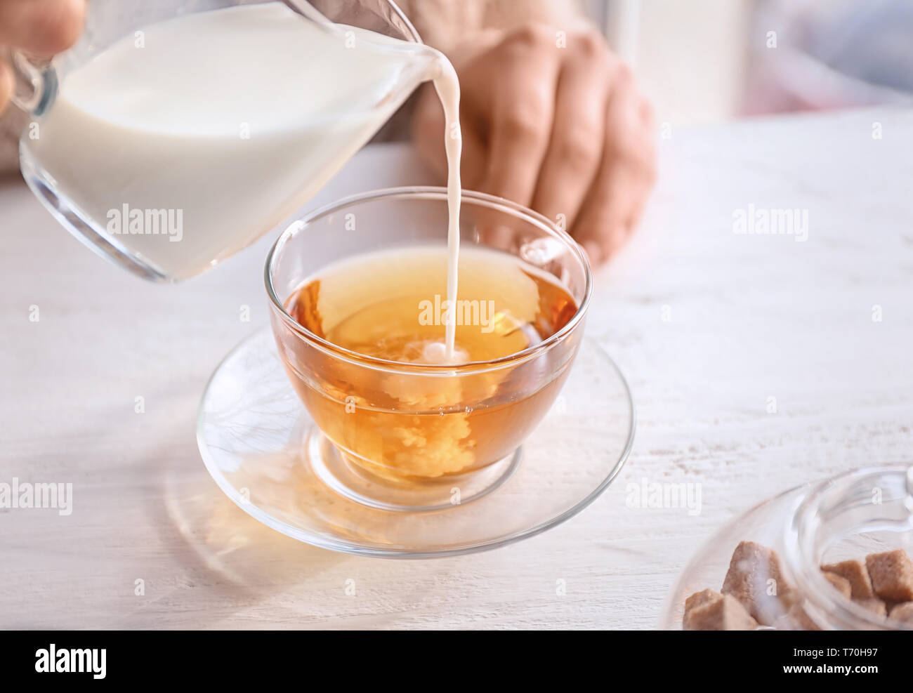 Woman pouring aromatic tea cup hi-res stock photography and images - Alamy