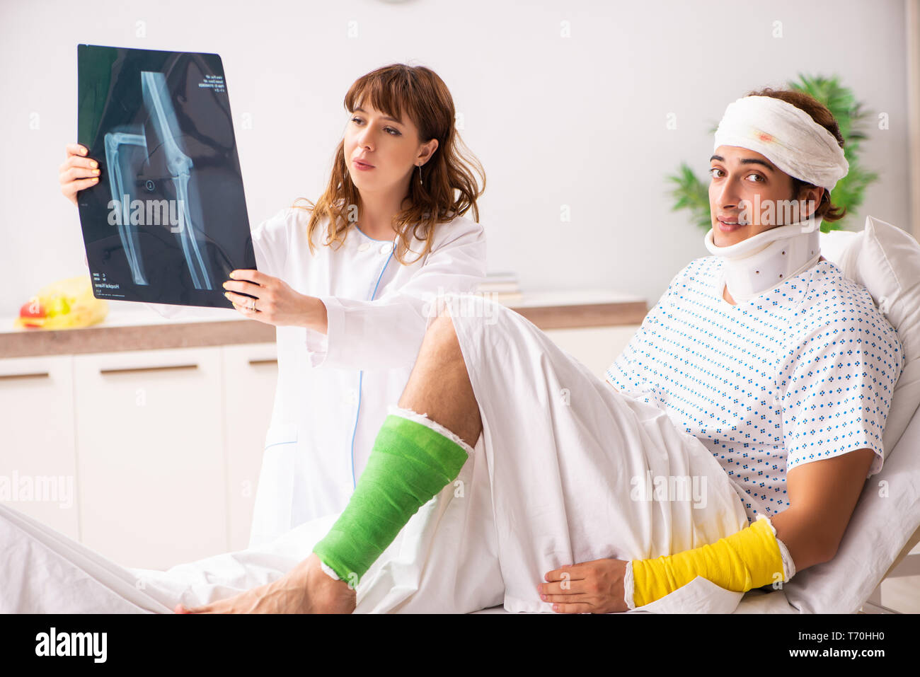 Young doctor examining injured patient Stock Photo - Alamy