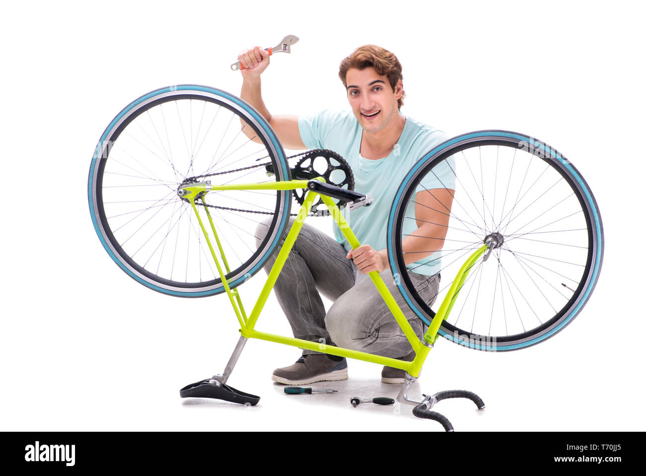 Man repairing his bike isolated on white background Stock Photo - Alamy