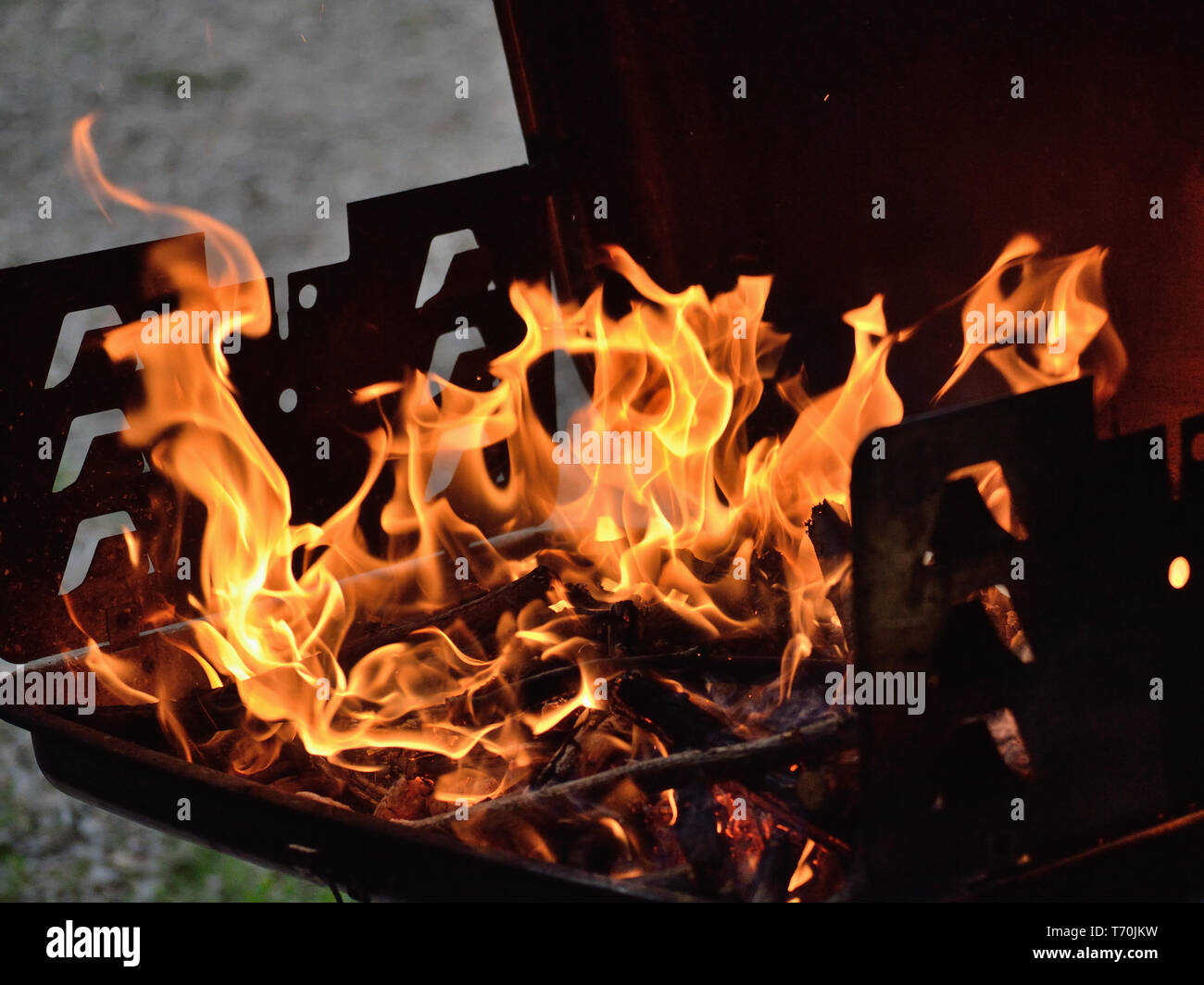 Burning firewood with flame in barbecue grill Stock Photo - Alamy