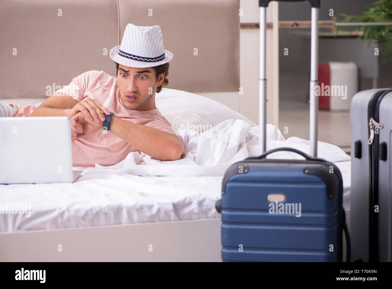 Man in bedroom packing bag hi-res stock photography and images - Alamy