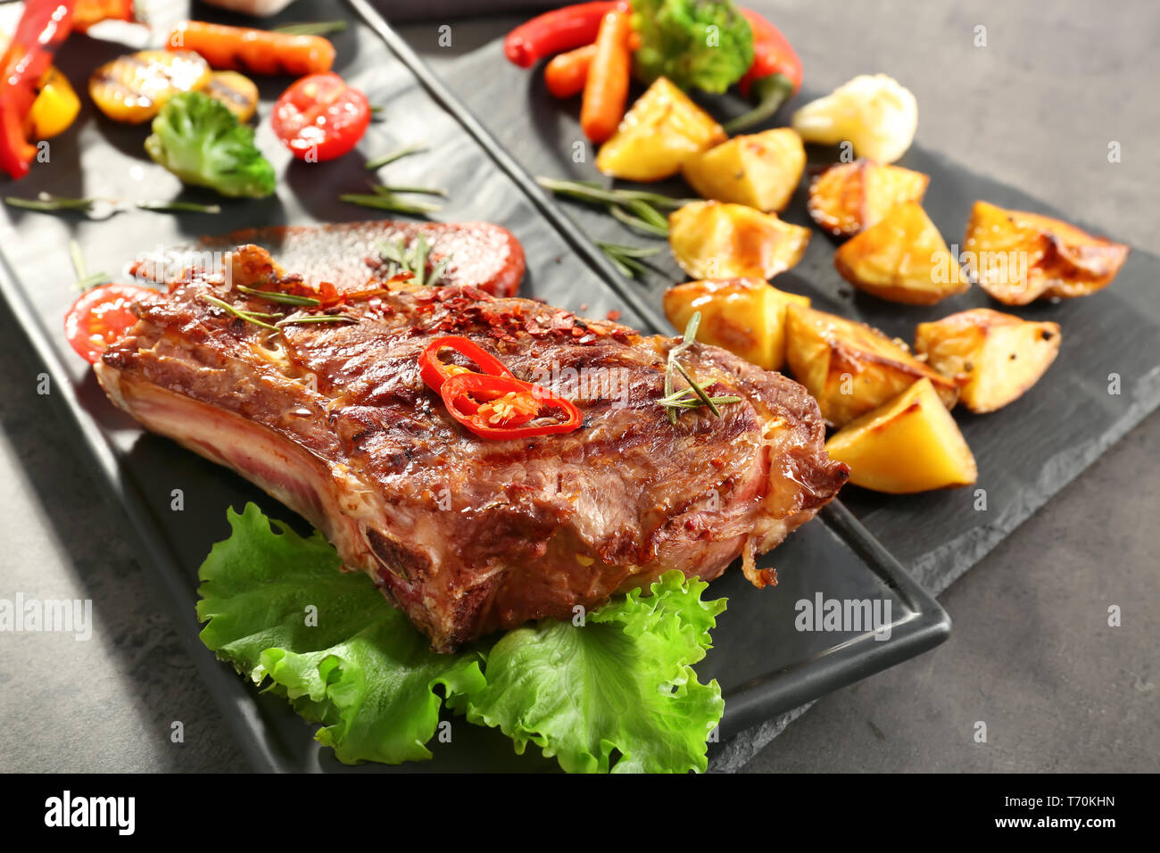 Meat served with vegetable garnish on plate Stock Photo - Alamy
