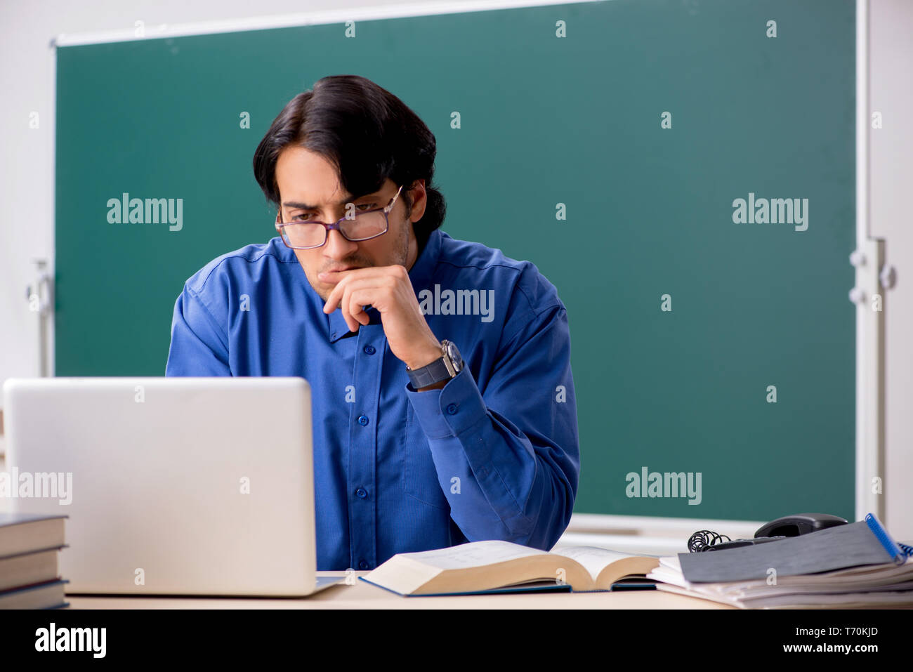 Focused young male teacher hi-res stock photography and images - Alamy