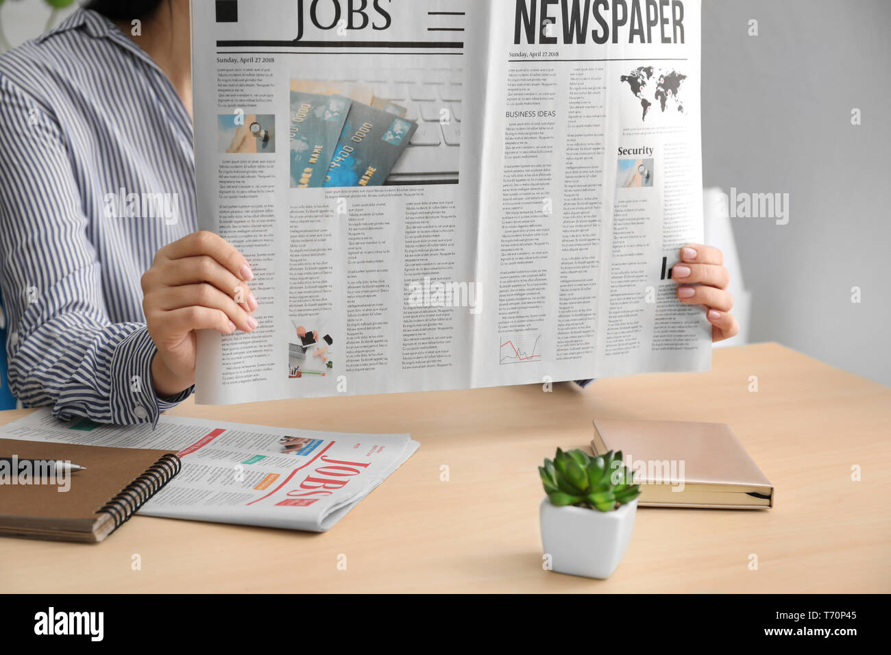 Woman sitting reading broadsheet newspaper hi-res stock photography and ...