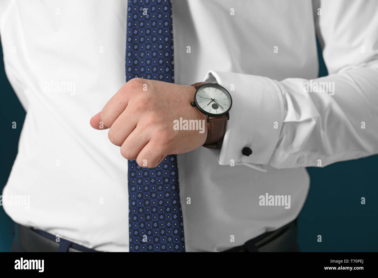 Man looking at his watch, closeup. Time management concept Stock Photo ...