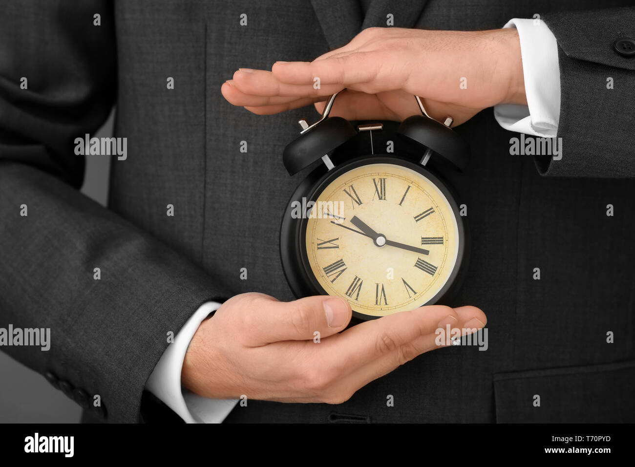 Man holding alarm clock, closeup. Time management concept Stock Photo ...