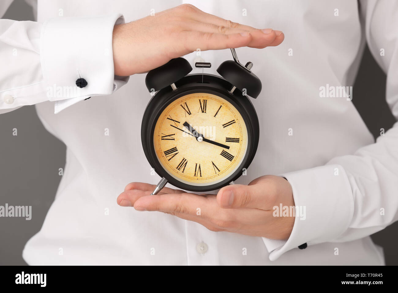 Man holding alarm clock, closeup. Time management concept Stock Photo ...
