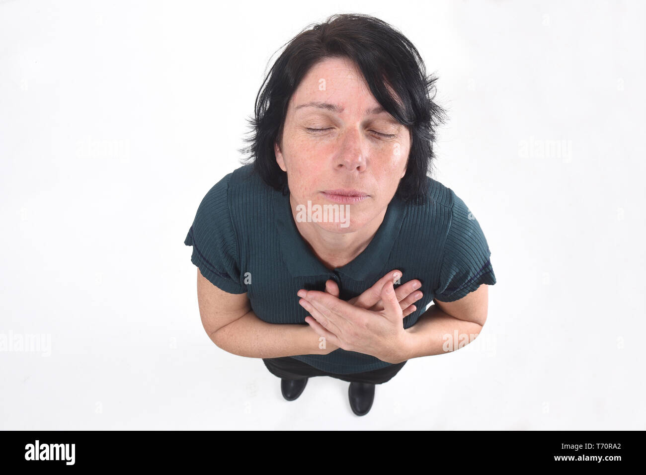 woman with hand on heart Stock Photo - Alamy