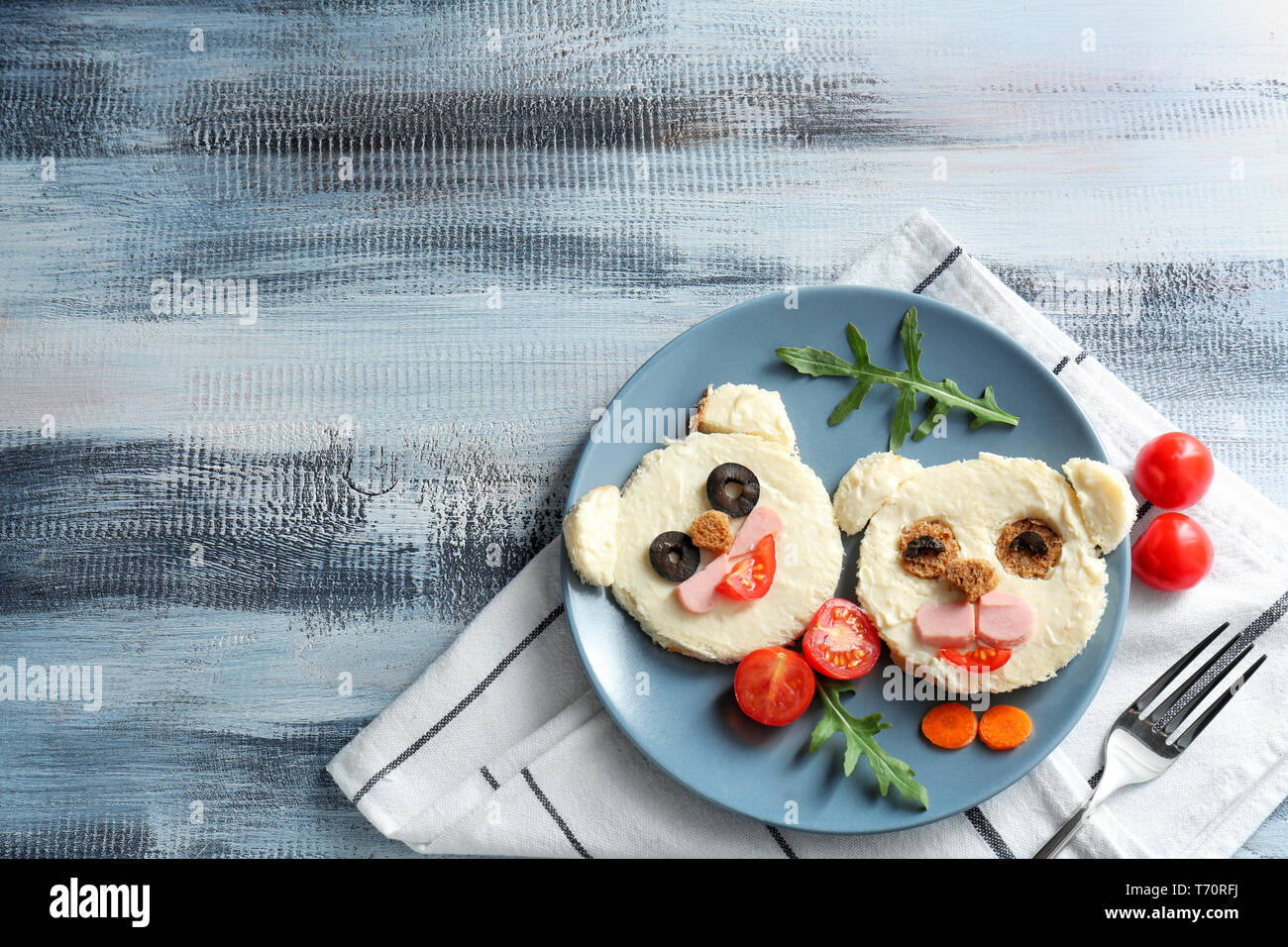 Plate with creative toasts for children on wooden table, top view Stock ...