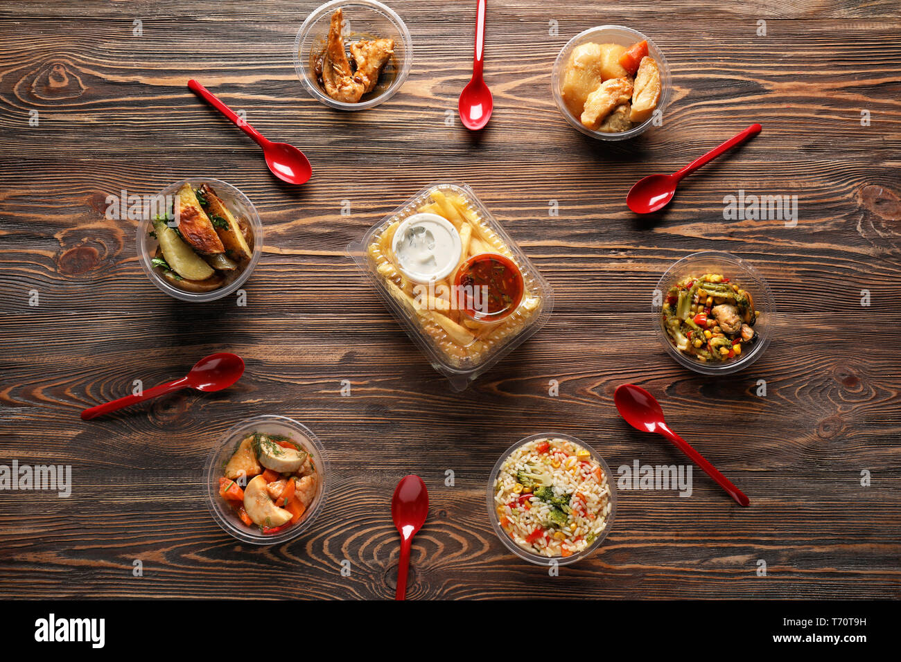 Plastic containers with delicious food on wooden table. Delivery ...