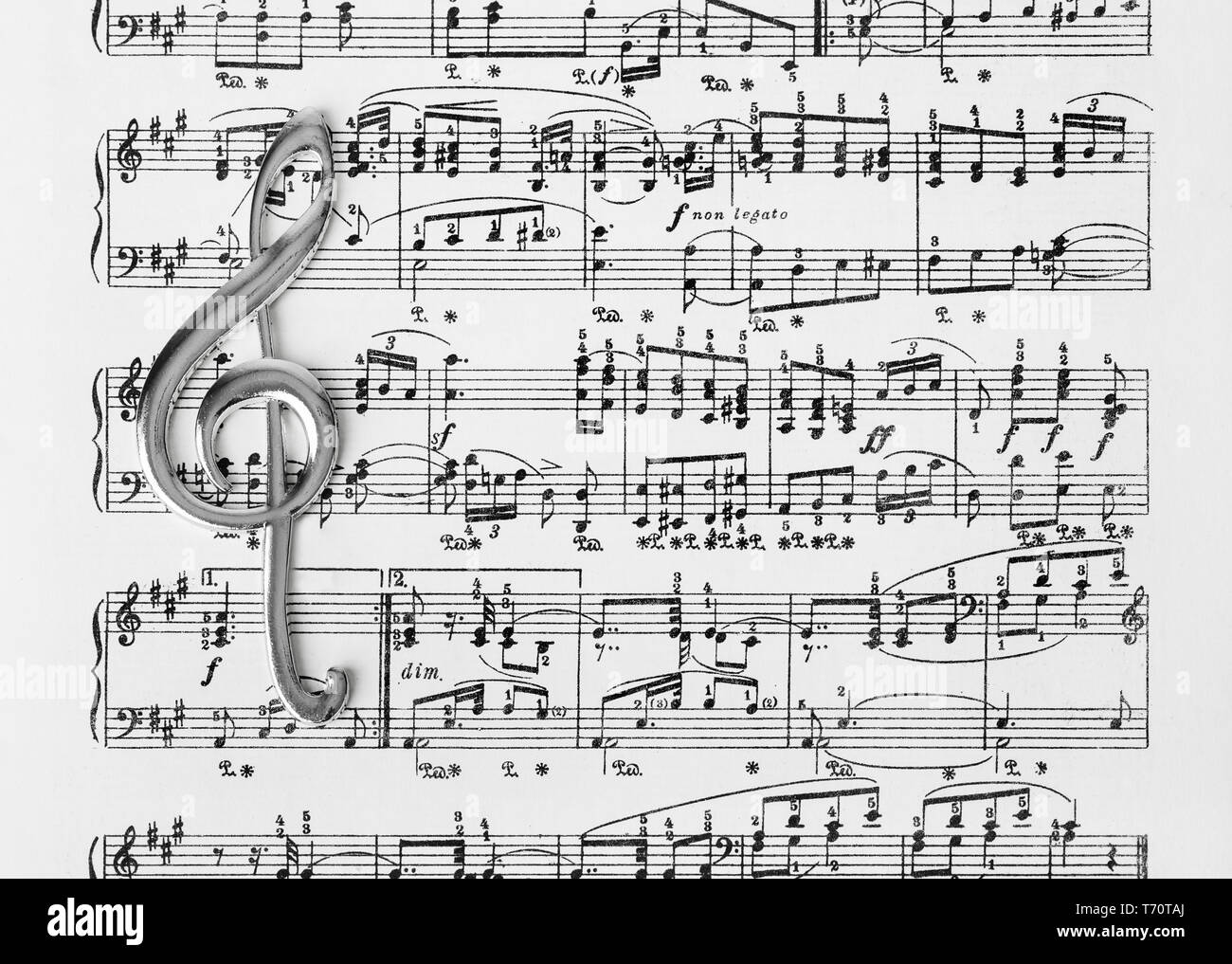 Treble clef on music sheet - musical background Stock Photo - Alamy