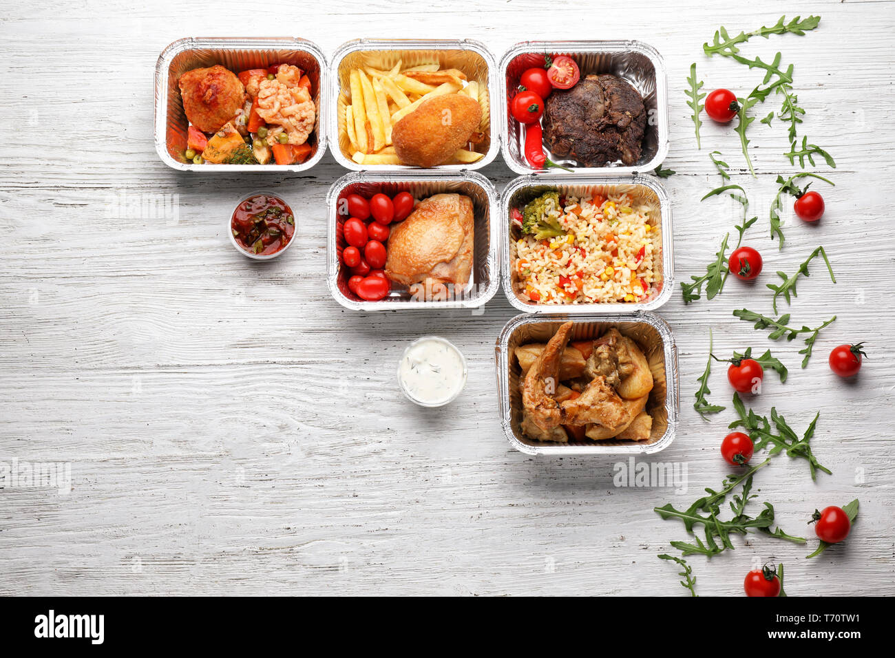 Containers with delicious food on wooden table. Delivery service Stock ...