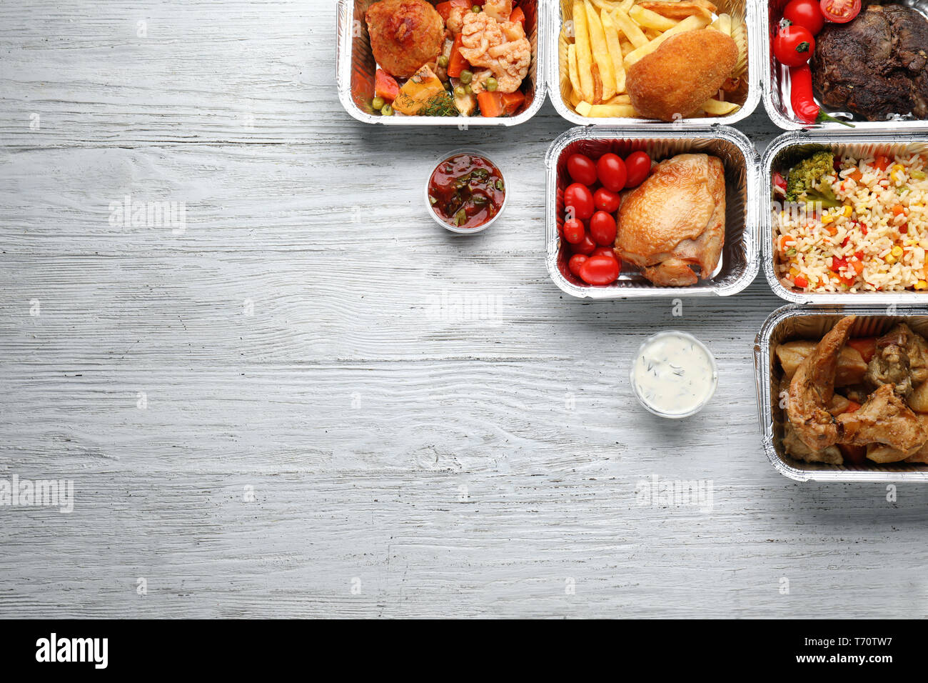 Containers with delicious food on wooden table. Delivery service Stock ...