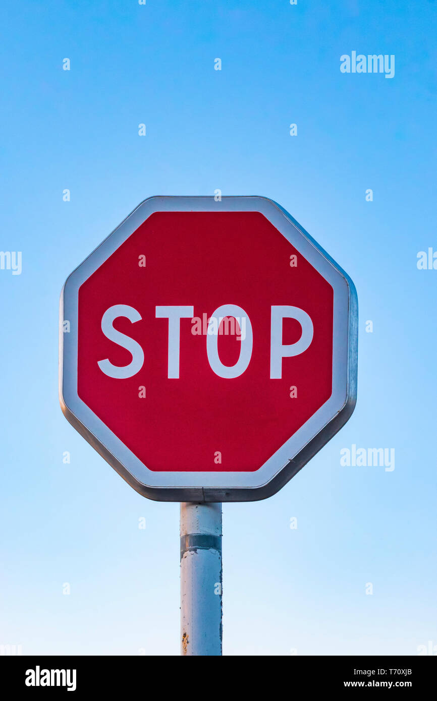 stop sign against a blue sky Stock Photo - Alamy