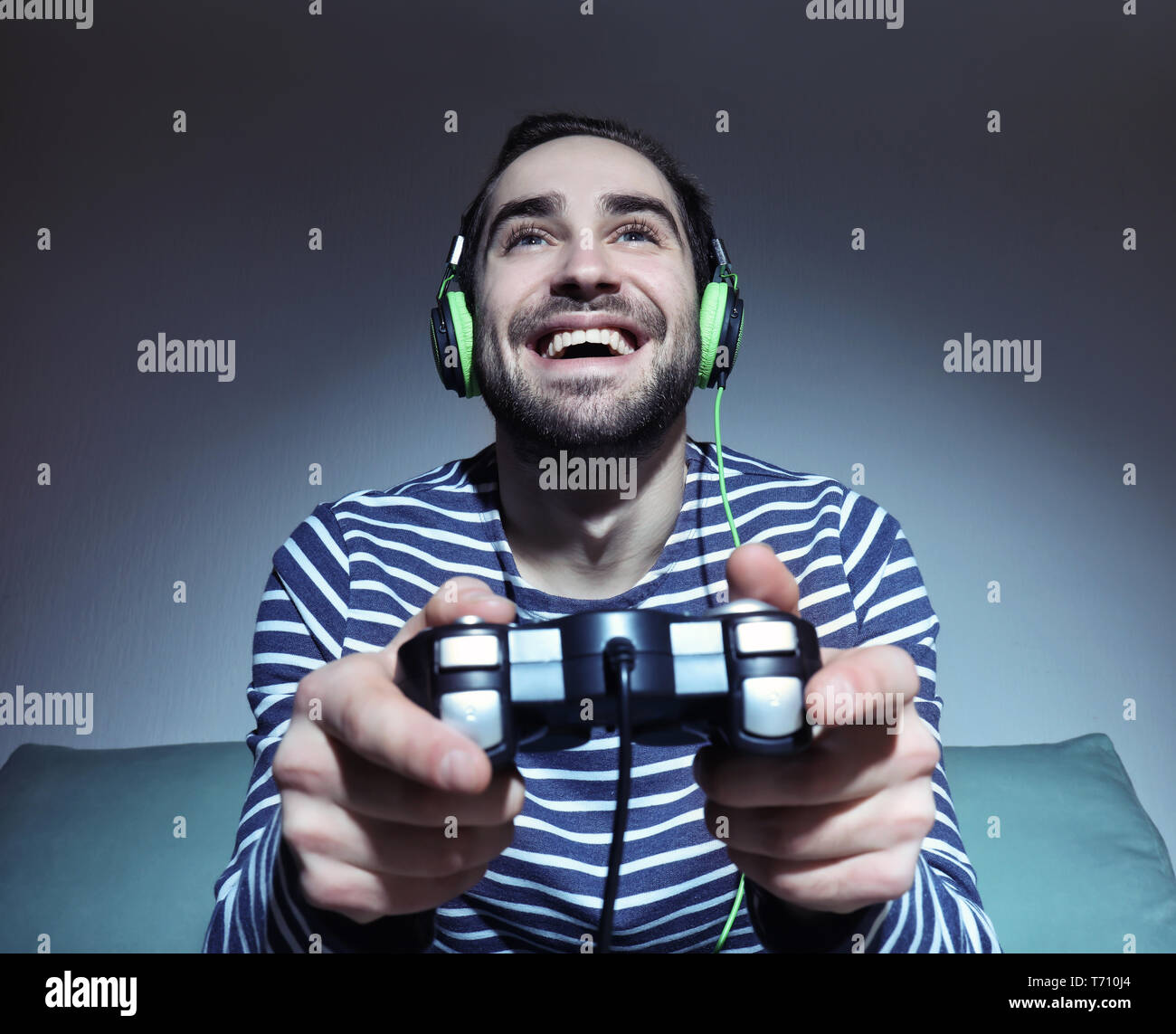 Young man playing video games at home Stock Photo - Alamy