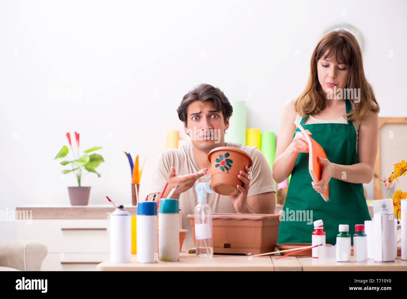 Couple decorating pots in workshop during class Stock Photo - Alamy