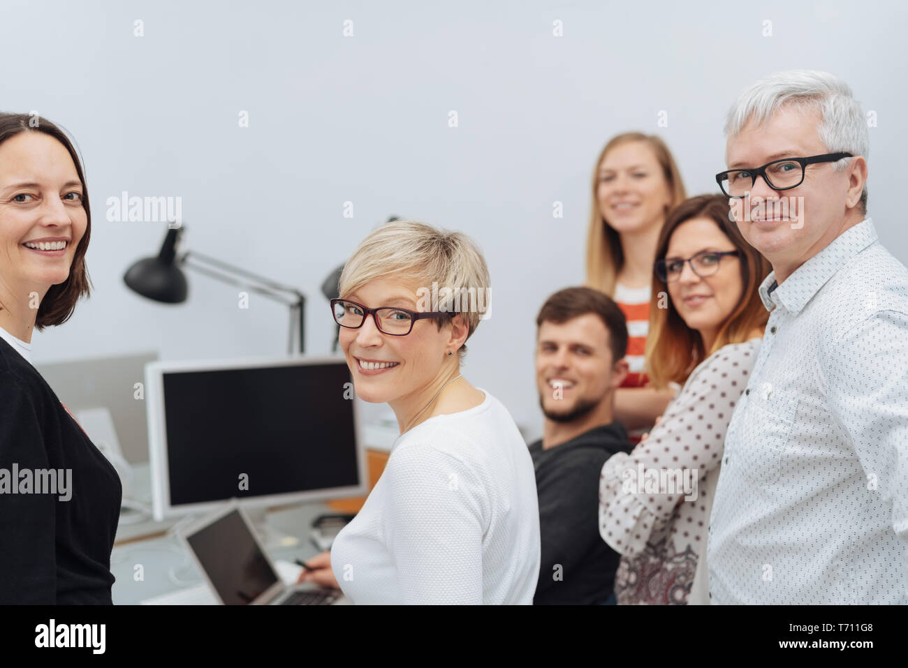 Co workers around computer hi-res stock photography and images - Alamy