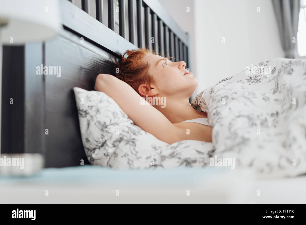 Young woman bed bedroom lying down arms hi-res stock photography and ...