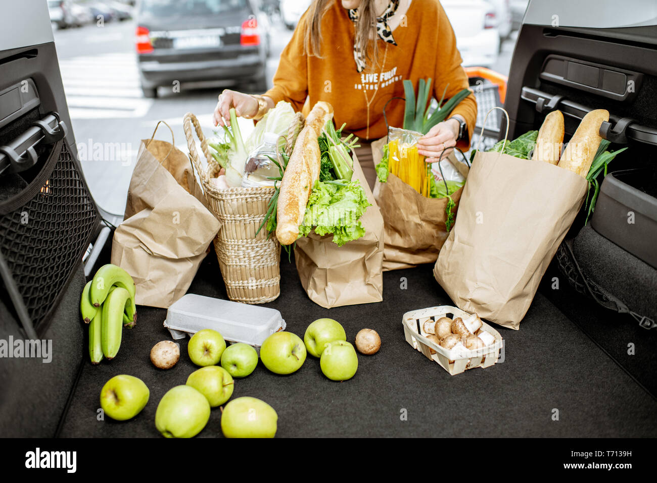 Woman loading car trunk hi-res stock photography and images - Alamy