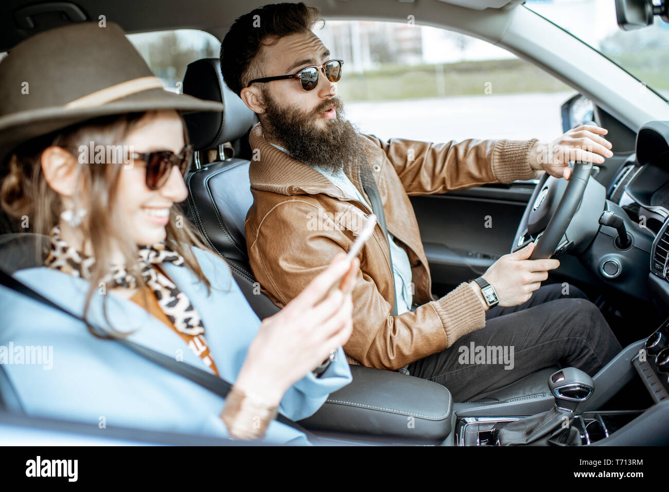 Young and happy stylish couple driving luxury car in the city Stock ...