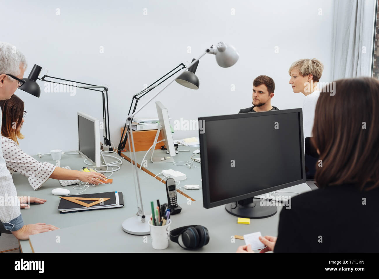 Co workers around computer hi-res stock photography and images - Alamy