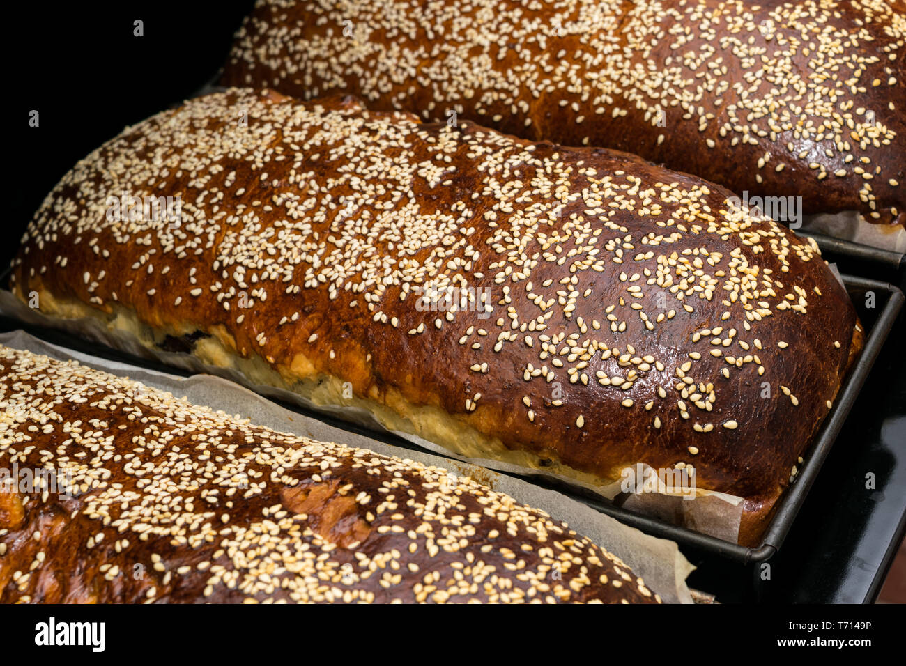 fresh baked sweet bread covered with sesame seeds Stock Photo - Alamy