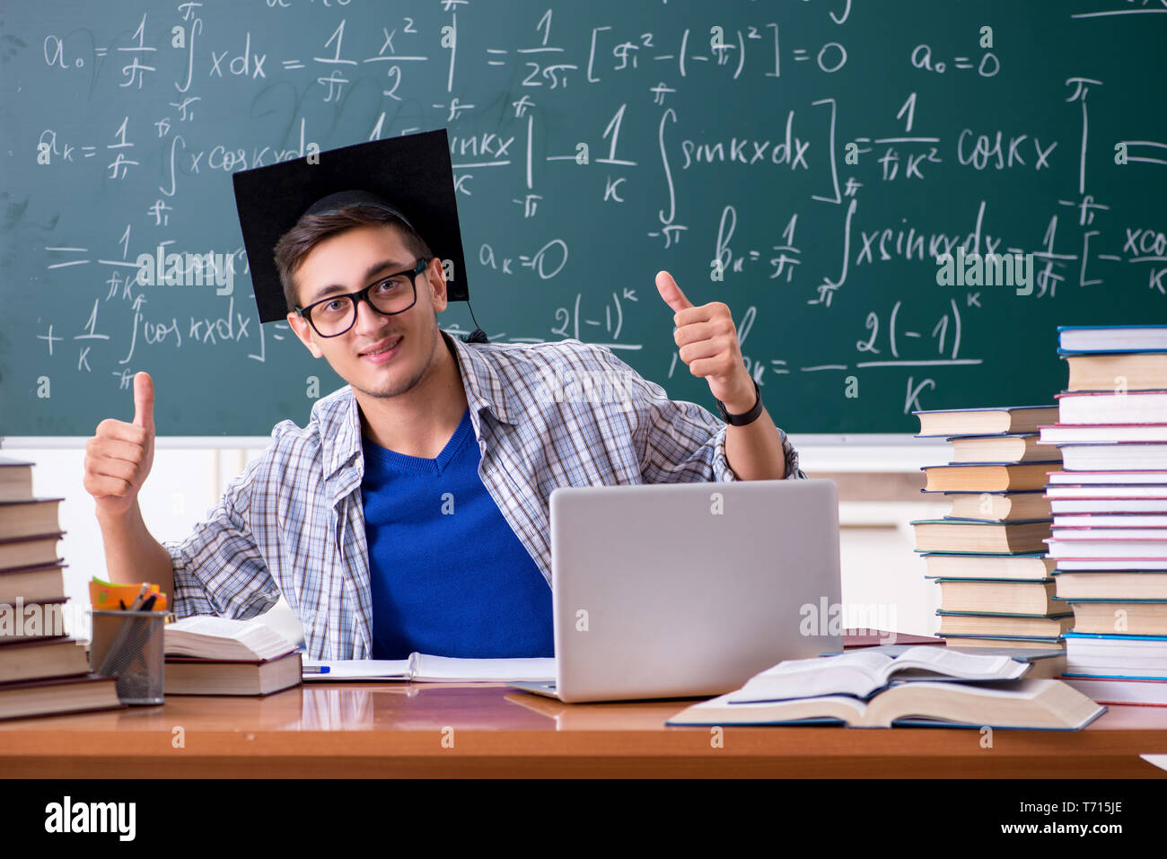 Young male student studying math at school Stock Photo - Alamy