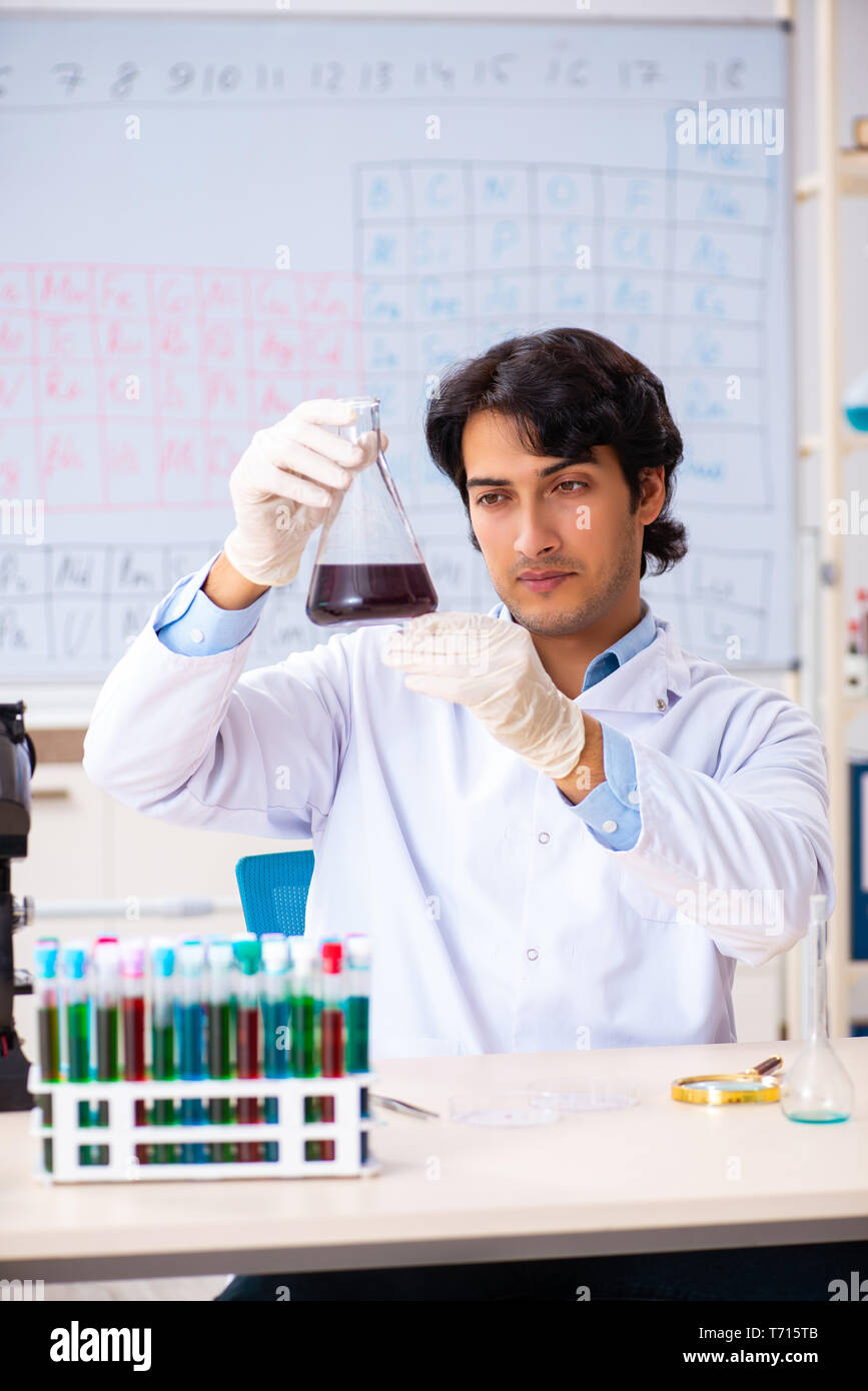 Young chemist working in the lab Stock Photo - Alamy