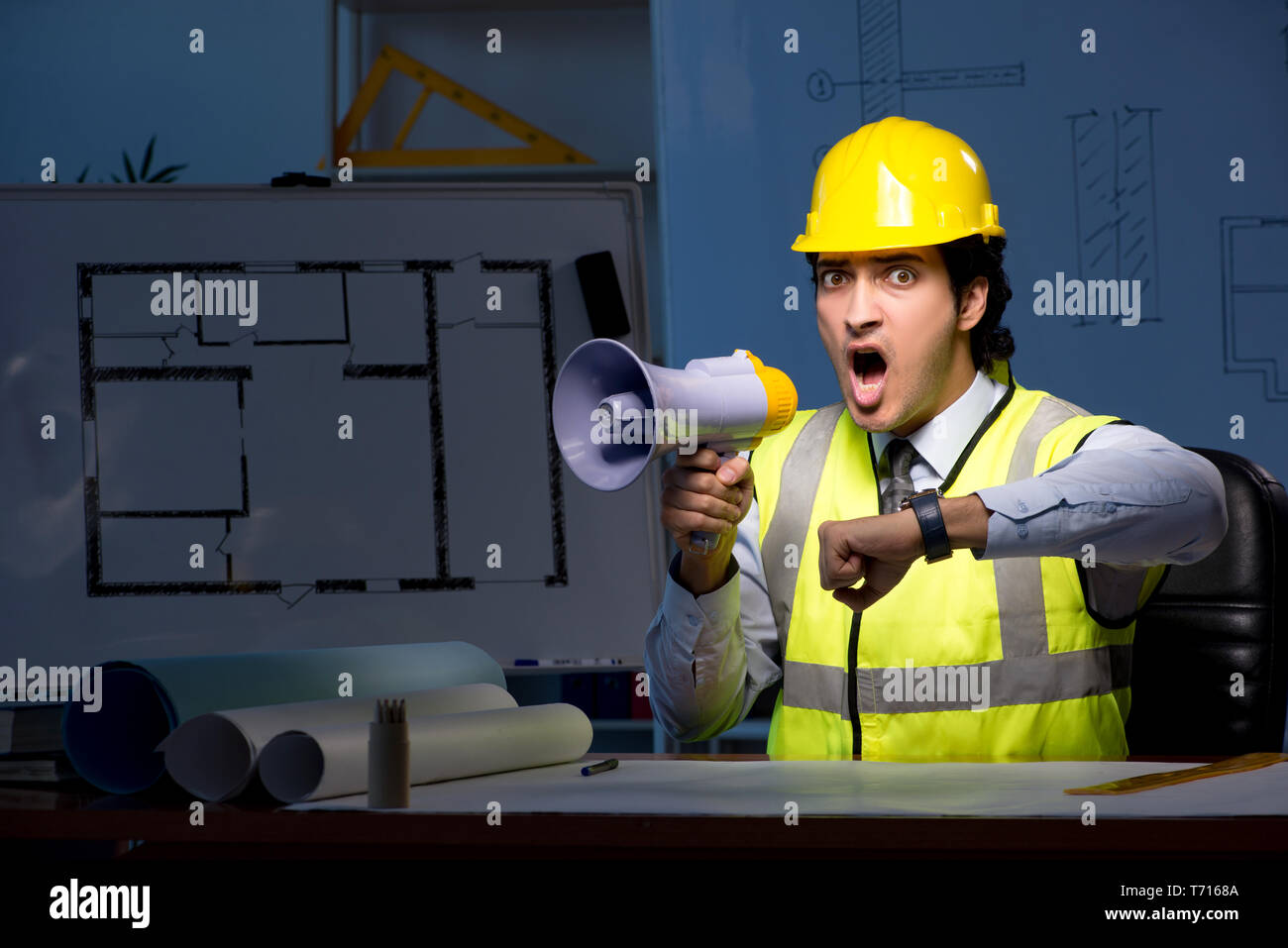 Young construction architect working on project at night Stock Photo ...
