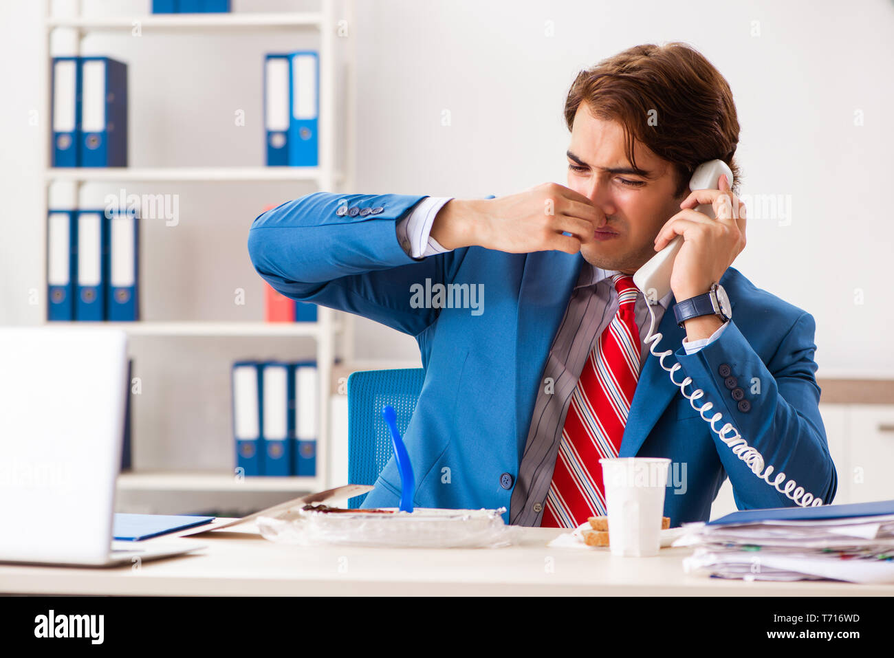 Man having meal at work during break Stock Photo - Alamy