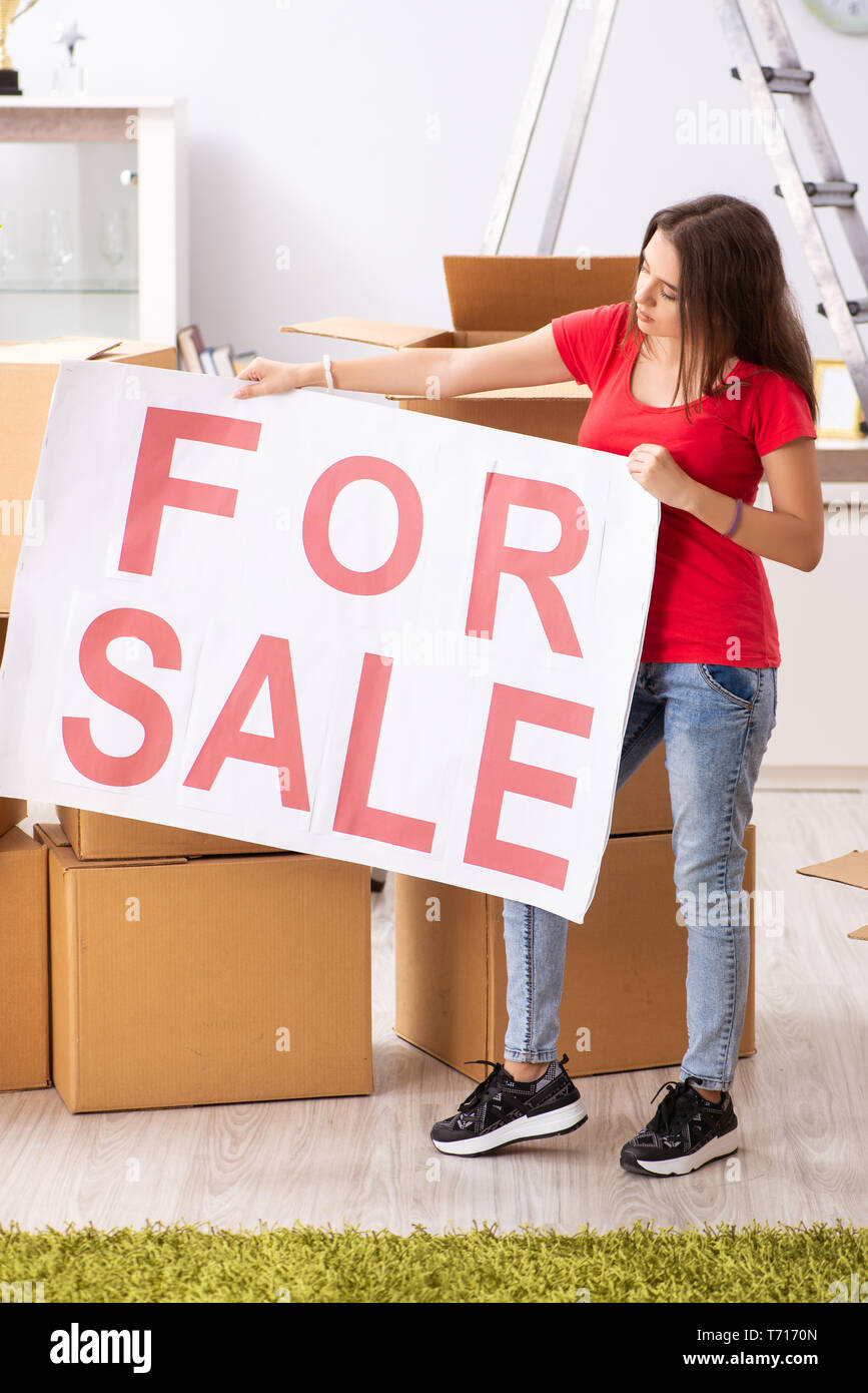 Young beautiful woman selling flat Stock Photo - Alamy