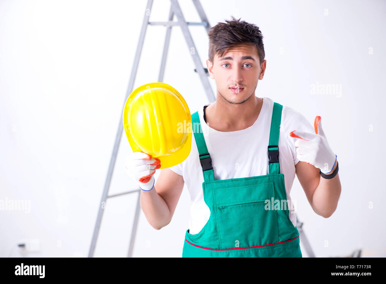 Young worker with protective equipment in safety concept Stock Photo ...