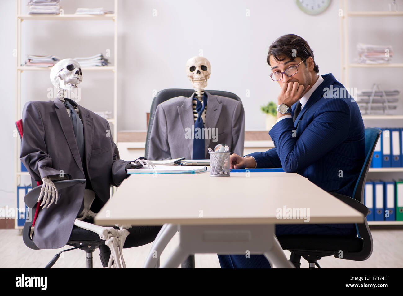 Funny business meeting with boss and skeletons Stock Photo - Alamy