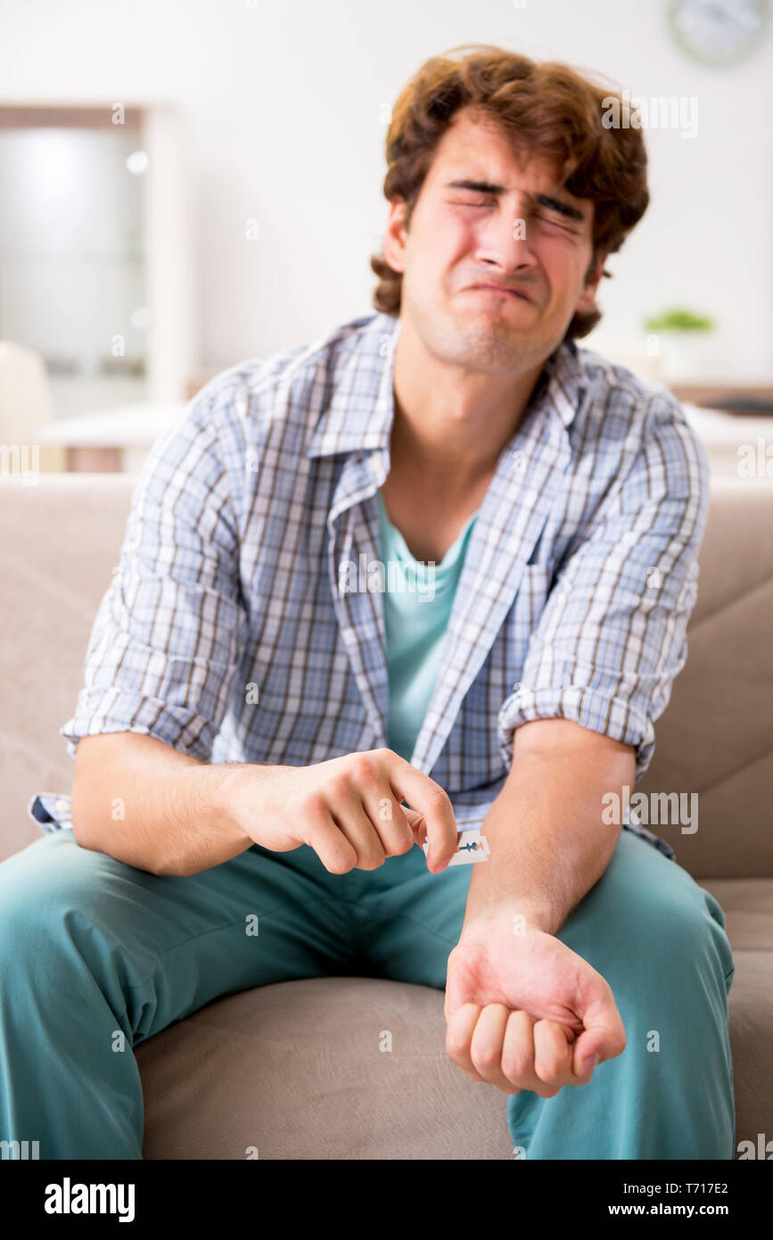 Young man committing suicide with razor blade Stock Photo - Alamy