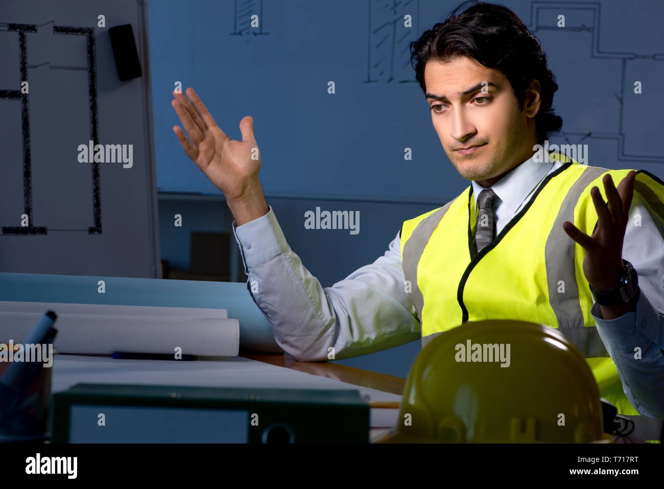 Young construction architect working on project at night Stock Photo ...