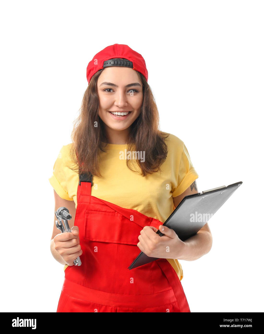 Female mechanic in uniform with clipboard and instruments on white ...