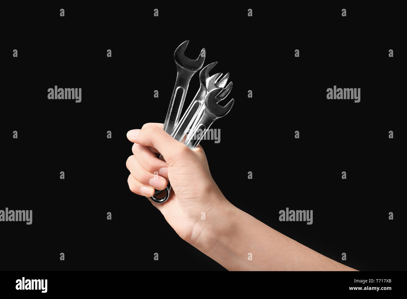 Female mechanic holding instruments on black background, closeup Stock ...