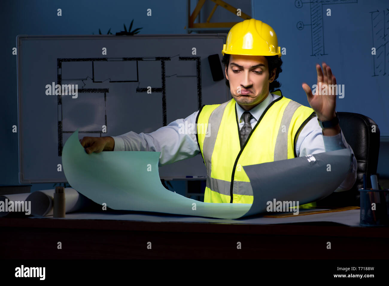 Young construction architect working on project at night Stock Photo ...