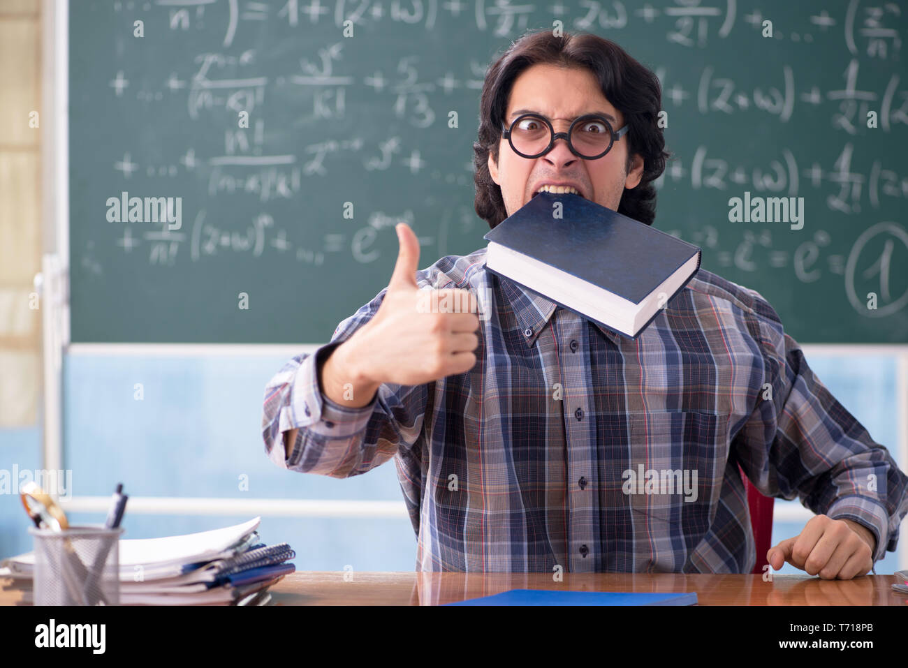 Young funny math teacher in front of chalkboard Stock Photo - Alamy